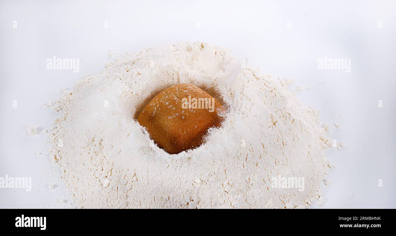Bread Falling in Flour against White Background Stock Photo - Alamy