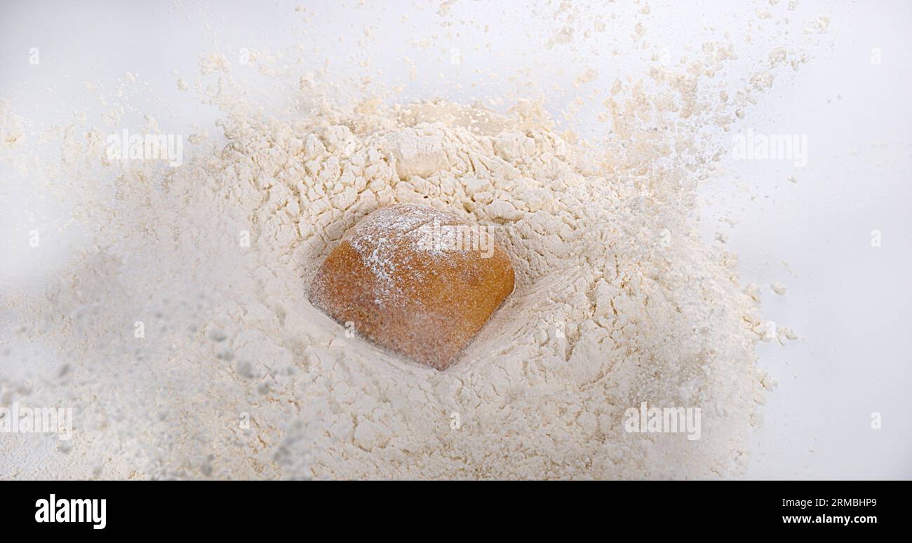 Bread Falling in Flour against White Background Stock Photo - Alamy