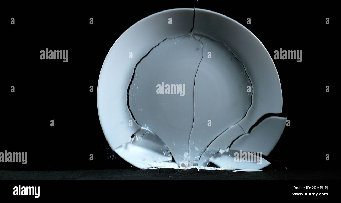 Plate falling and exploding on Black Background Stock Photo - Alamy