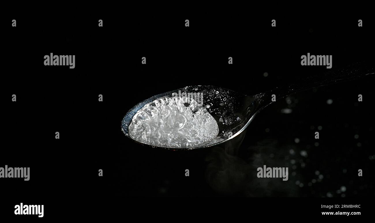 Drug, Cocaine in spoon against black background Stock Photo - Alamy