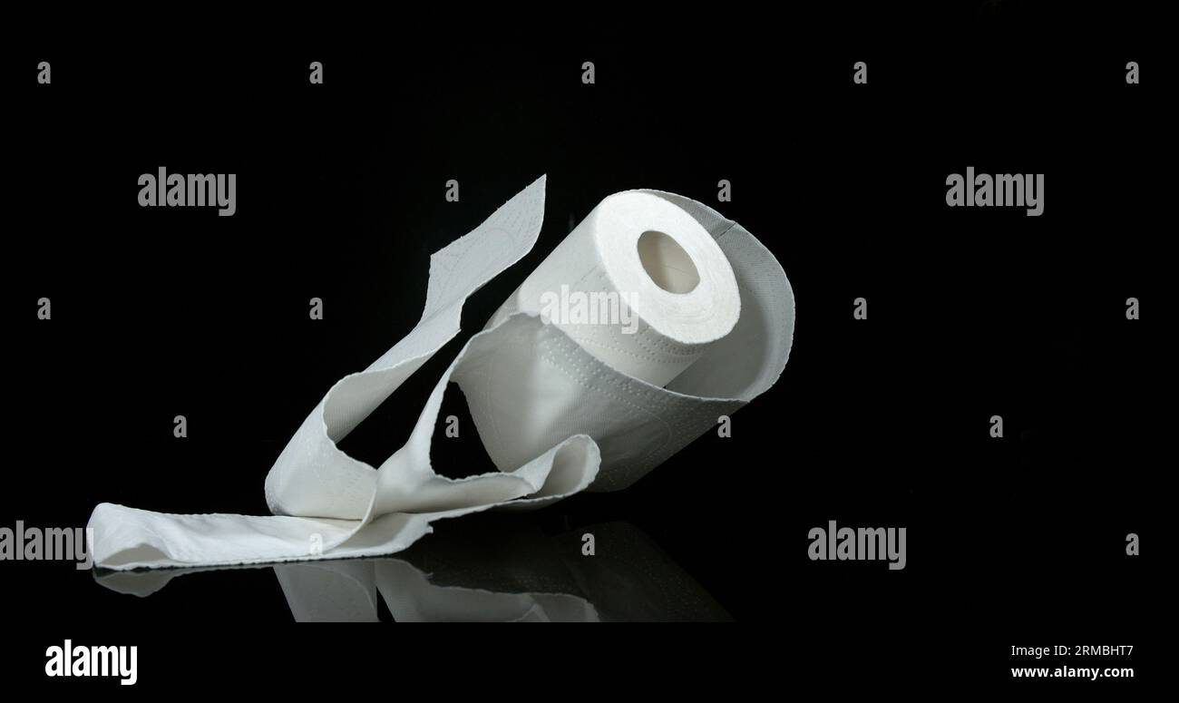 Roll of Toilet Paper Falling on Black Background Stock Photo - Alamy