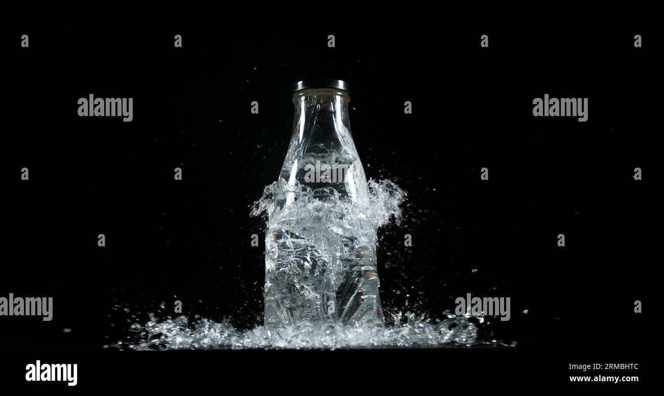 Bottle Falling and exploding on Black Background Stock Photo - Alamy
