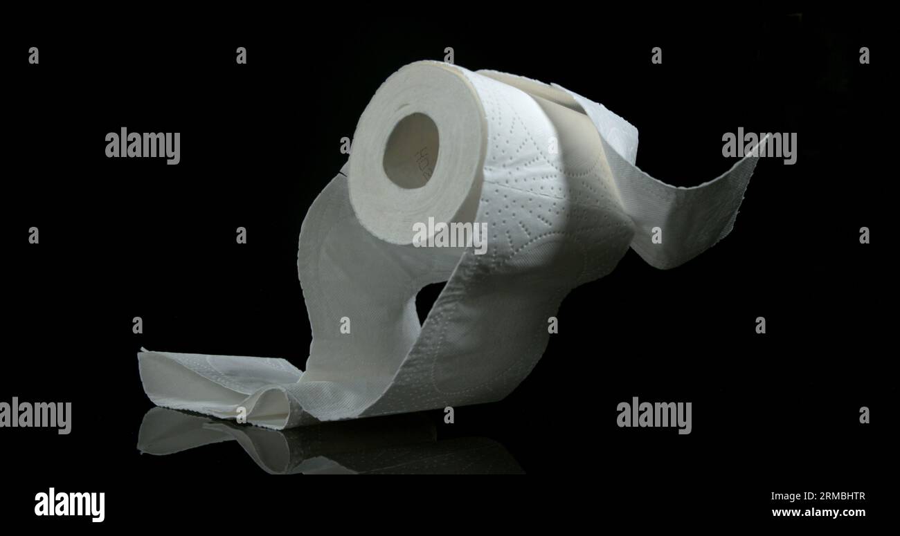 Roll of Toilet Paper Falling on Black Background Stock Photo - Alamy