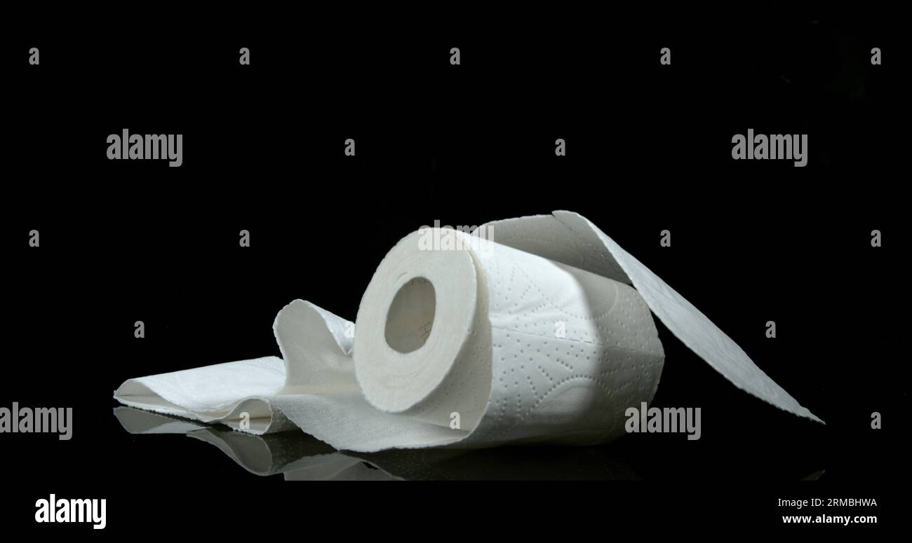 Roll of Toilet Paper Falling on Black Background Stock Photo - Alamy