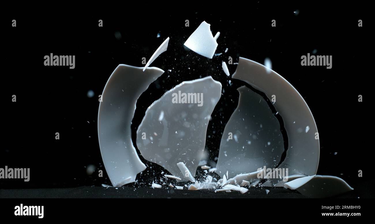 Plate falling and exploding on Black Background Stock Photo - Alamy