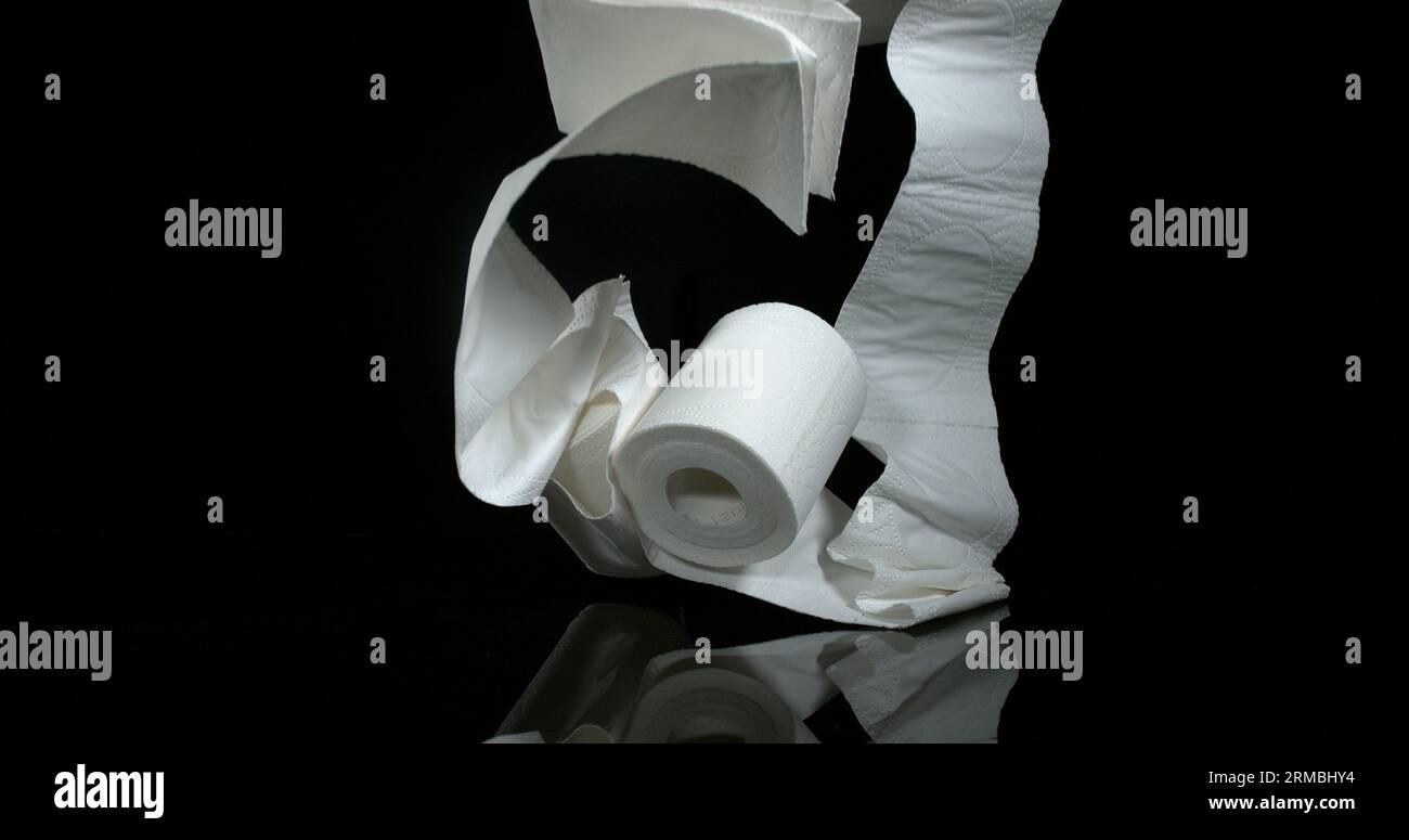 Roll of Toilet Paper Falling on Black Background Stock Photo - Alamy