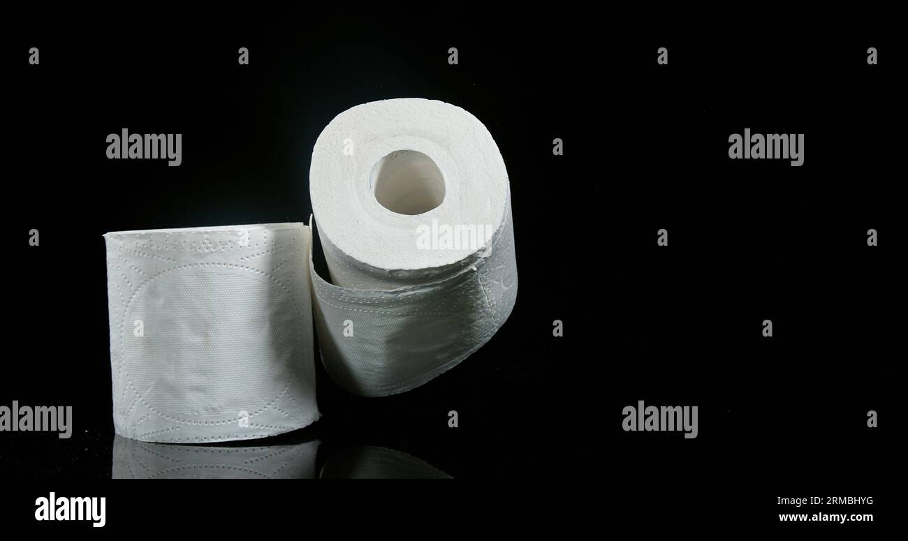 Roll of Toilet Paper Falling on Black Background Stock Photo - Alamy