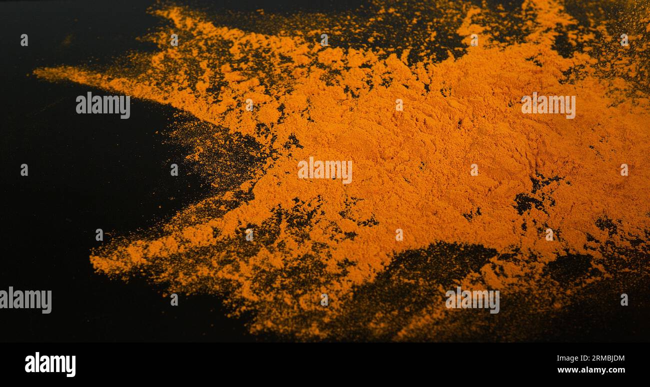 Turmeric, curcuma longa, Powder falling against Black Background ...