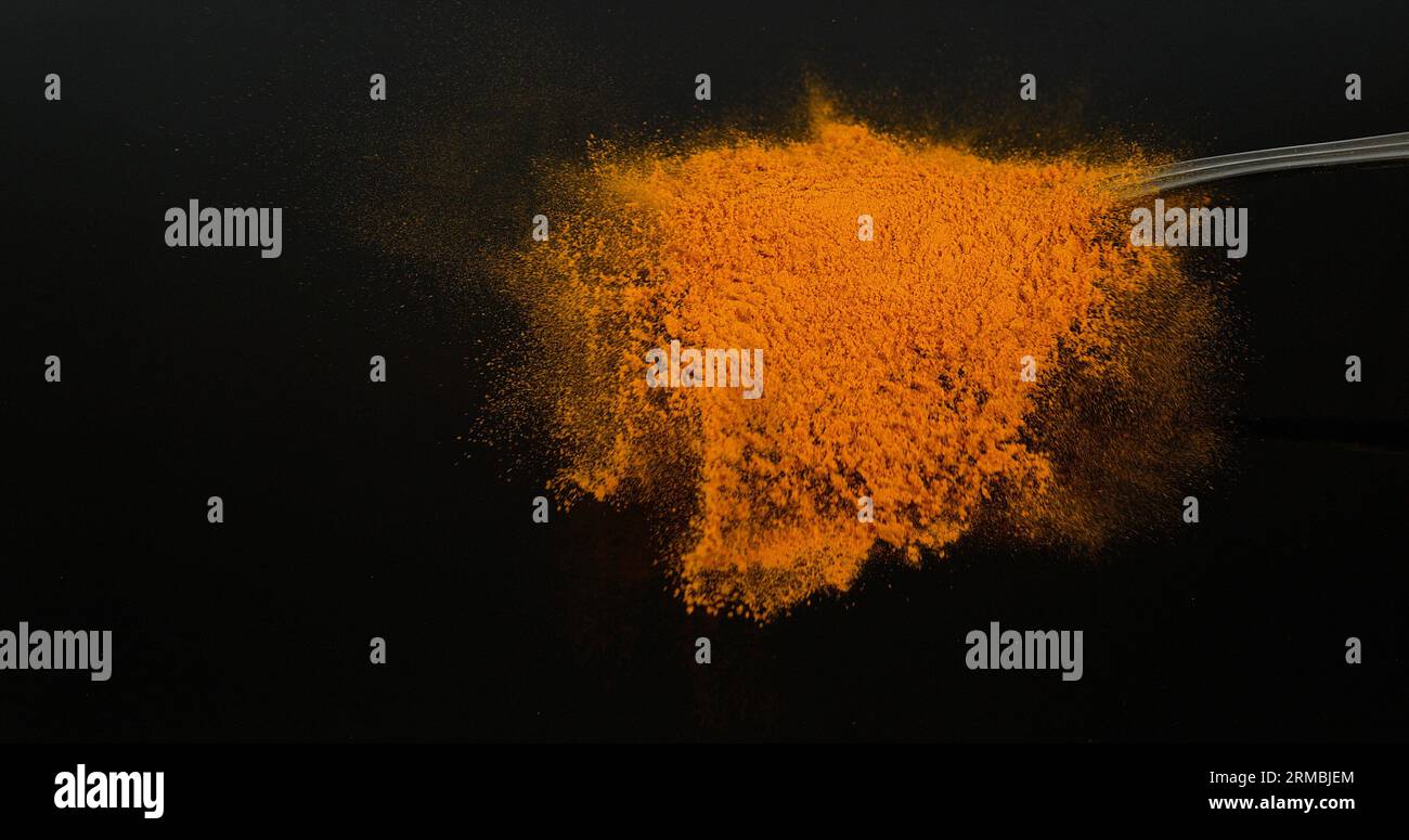 Turmeric, curcuma longa, curcuma Powder falling on Spoon, Indian Spice ...
