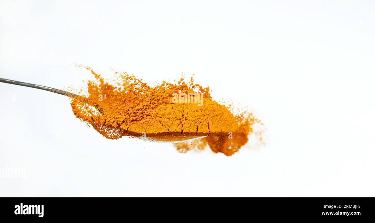 Turmeric, curcuma longa, curcuma Powder falling on Spoon, Indian Spice ...