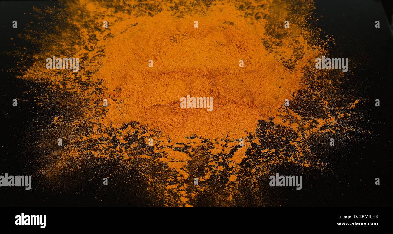 Turmeric, curcuma longa, Powder falling against Black Background ...