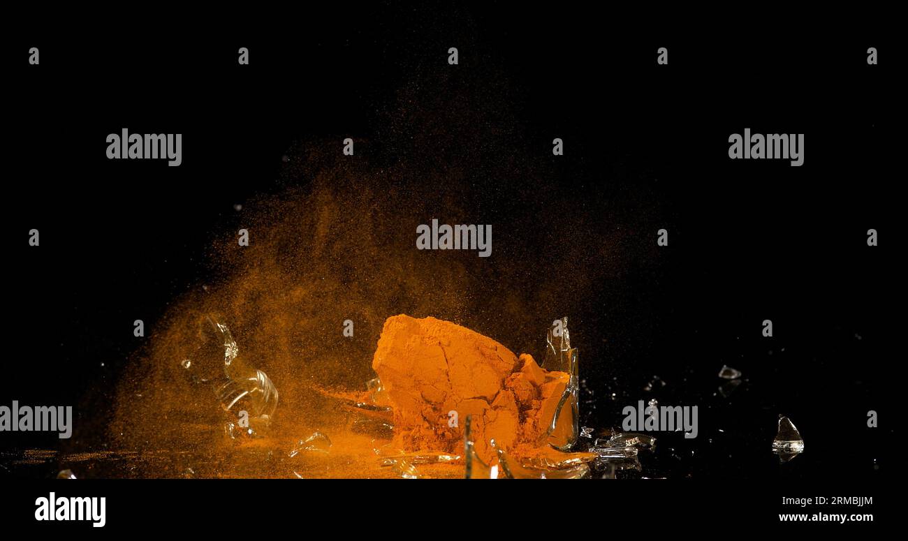 Turmeric, curcuma longa, Powder in a Small Jar Exploding against Black ...