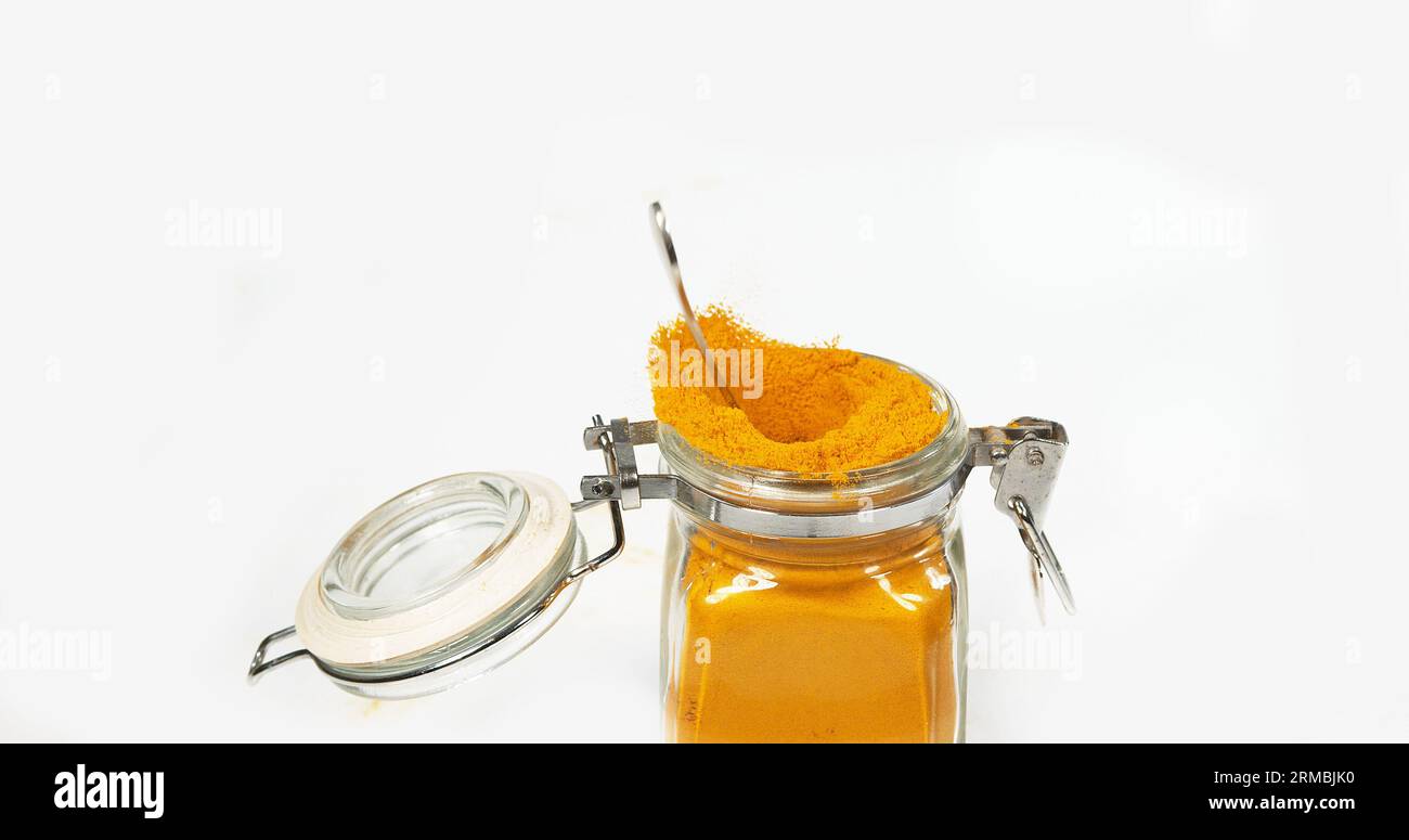 Turmeric, curcuma longa, Powder in a small Jar against White Background ...