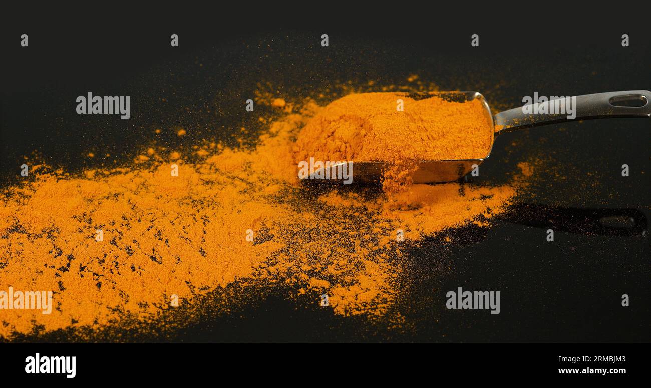 Turmeric, curcuma longa, Powder falling against Black Background ...