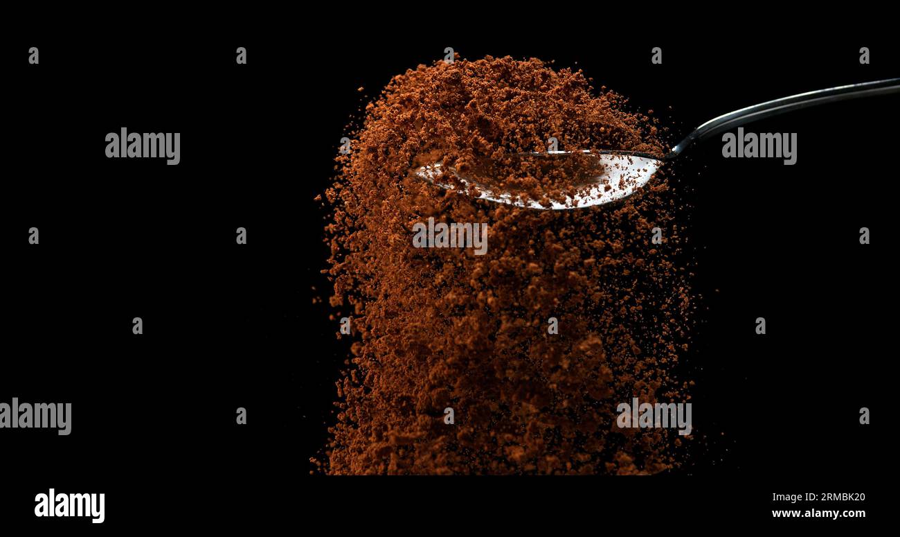 Nutmeg, myristica fragans, Powder falling from Spoon against Black ...