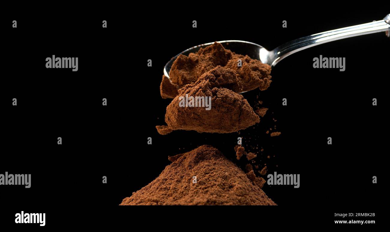 Nutmeg, myristica fragans, Powder falling from Spoon against Black ...