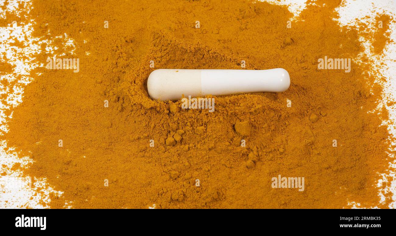 Curry Powder falling against white background Stock Photo - Alamy