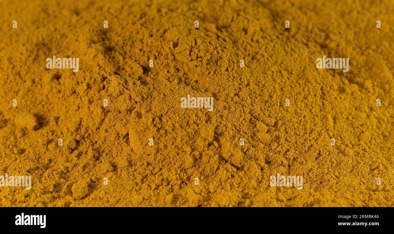 Curry Powder falling against white background Stock Photo - Alamy