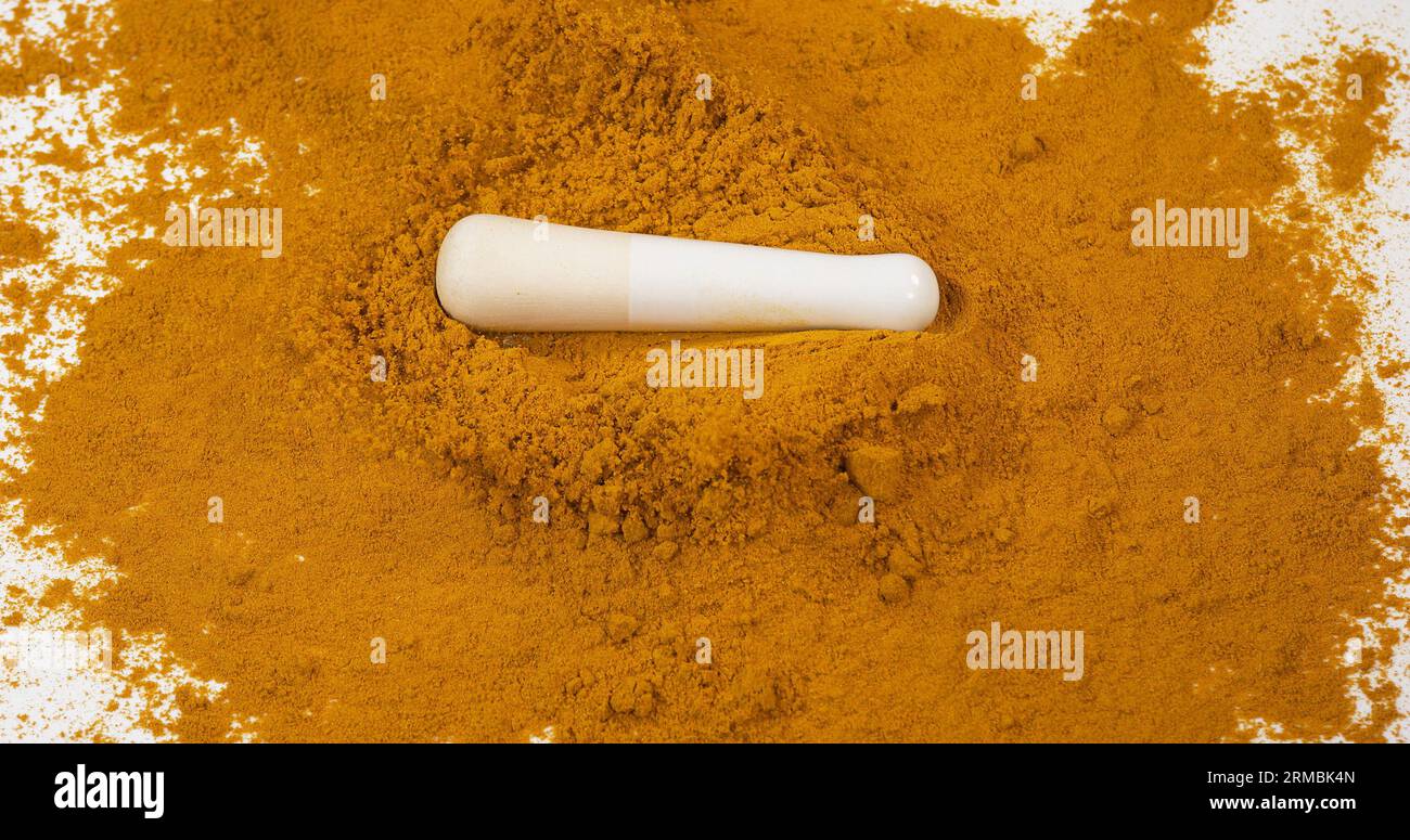 Curry Powder falling against white background Stock Photo - Alamy
