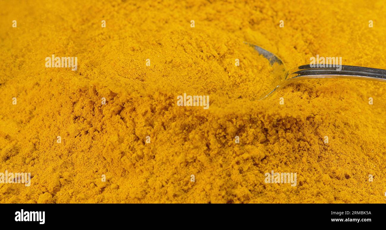 Curry Powder falling against white background Stock Photo - Alamy