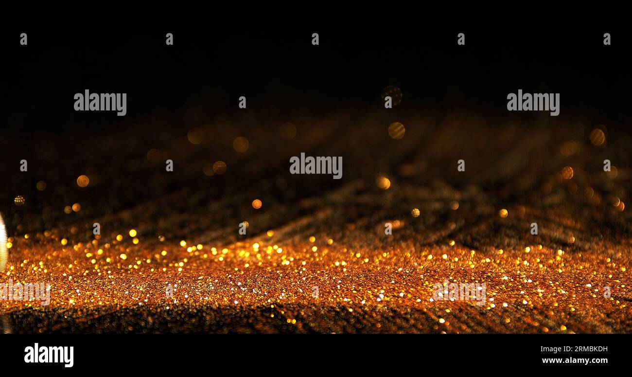 Gold Powder falling against Black Background Stock Photo - Alamy