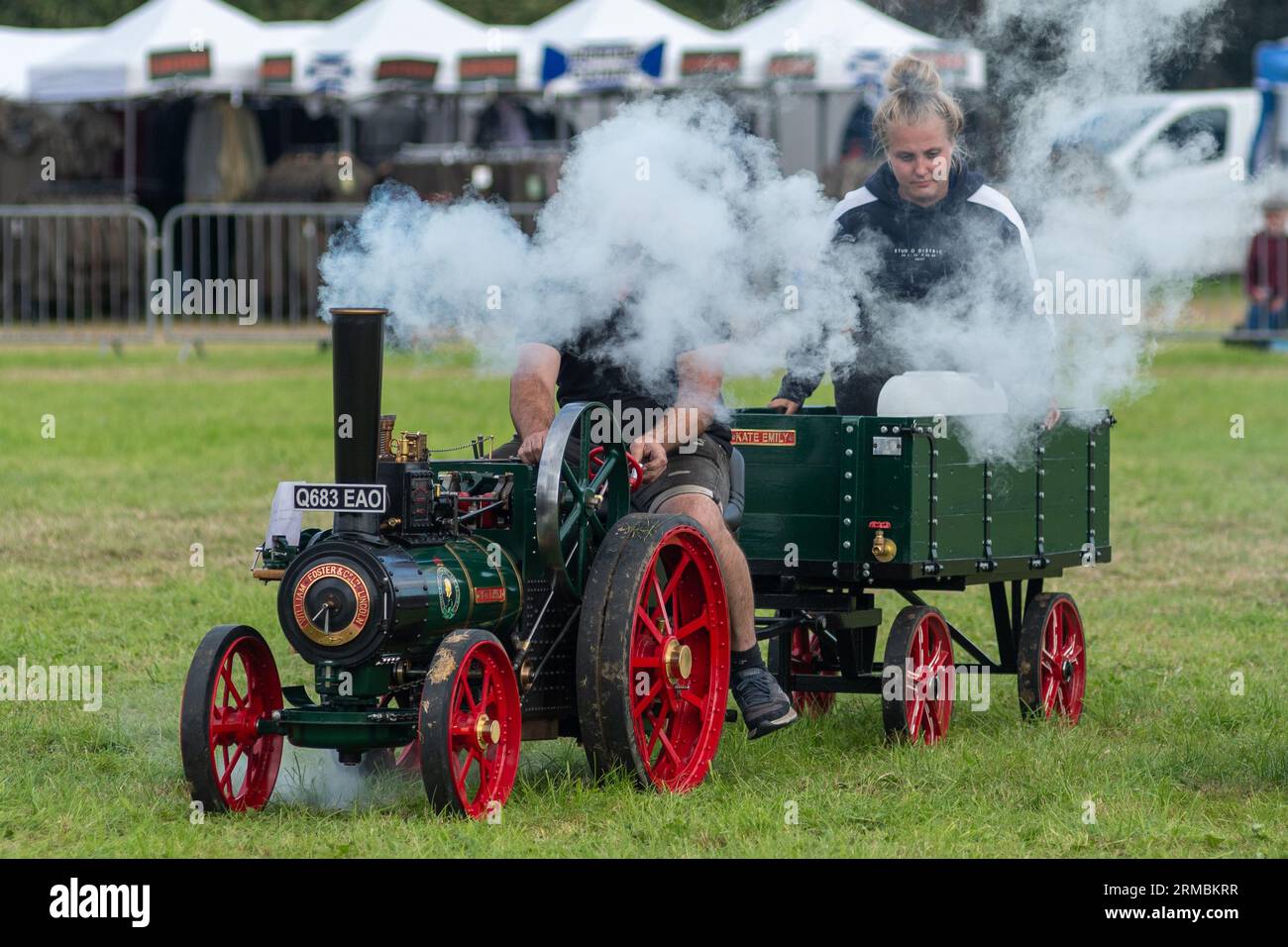 Miniature steam engine enthusiasts shrouded in steam while driving ...