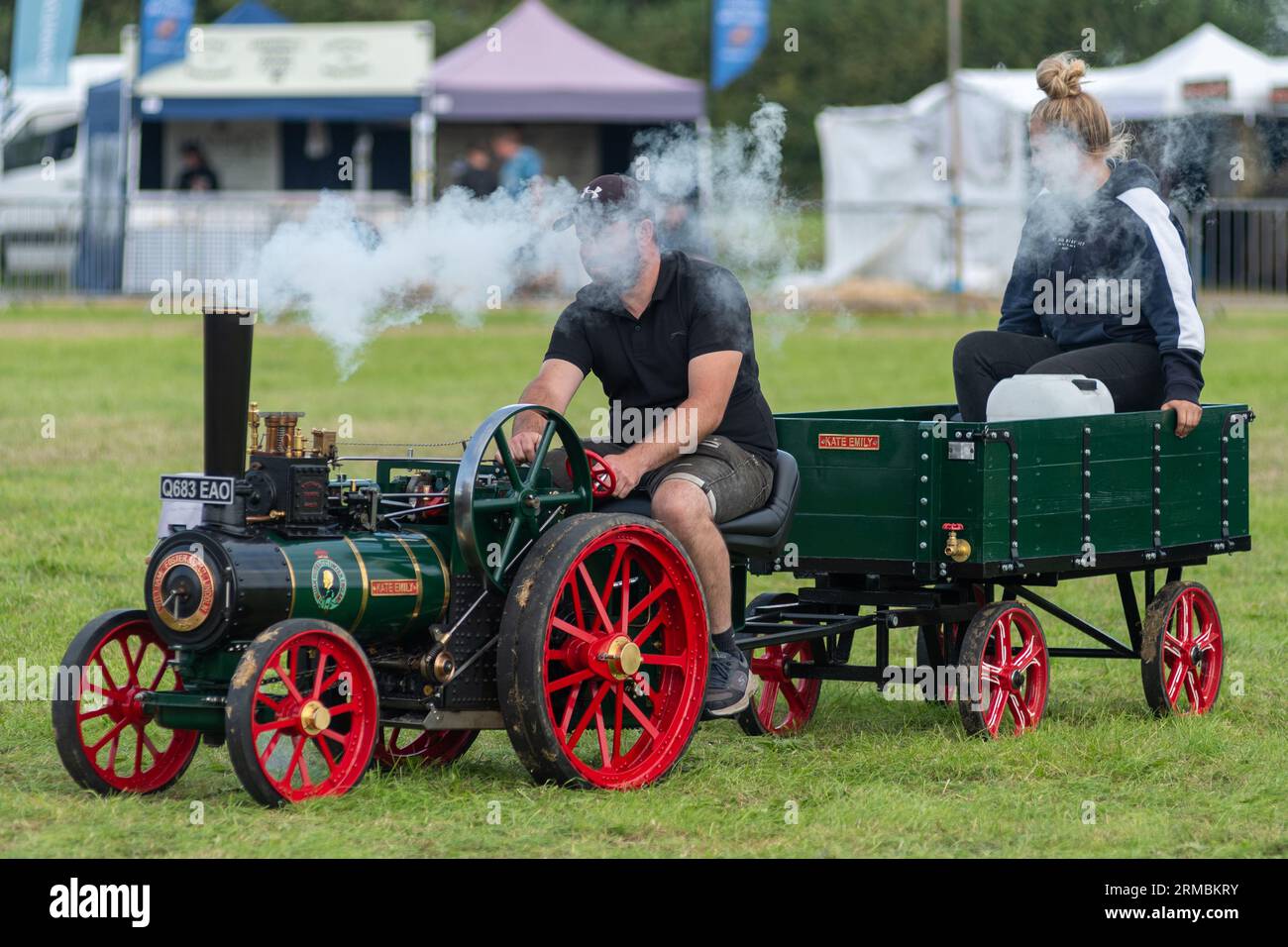 Miniature steam engine enthusiasts shrouded in steam while driving ...