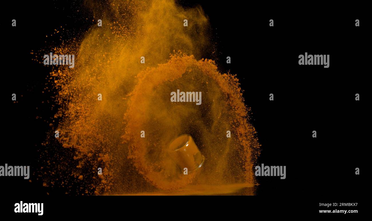 Turmeric, curcuma longa, Powder in a Small Jar falling against Black ...