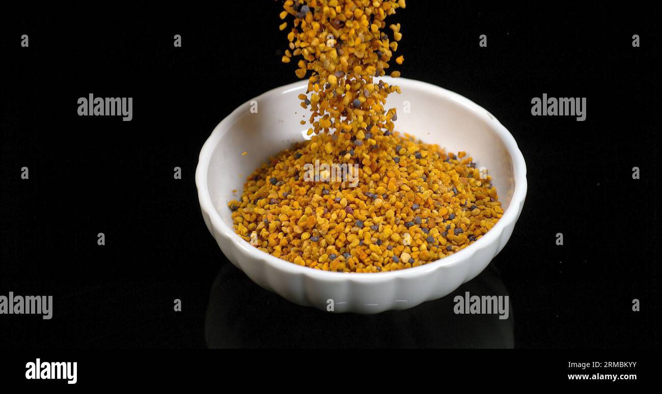 Pollen Dumplings Falling on Black Background Stock Photo - Alamy