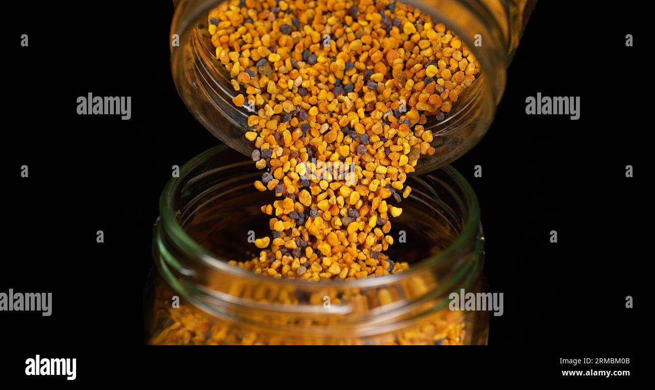 Pollen Dumplings Falling on Black Background Stock Photo - Alamy