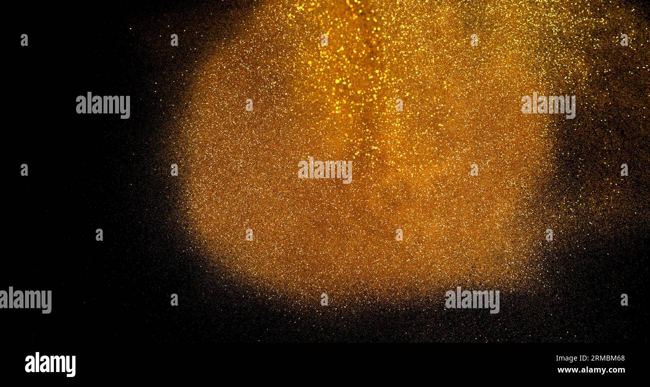 Gold Glitter Falling on Black Background Stock Photo - Alamy