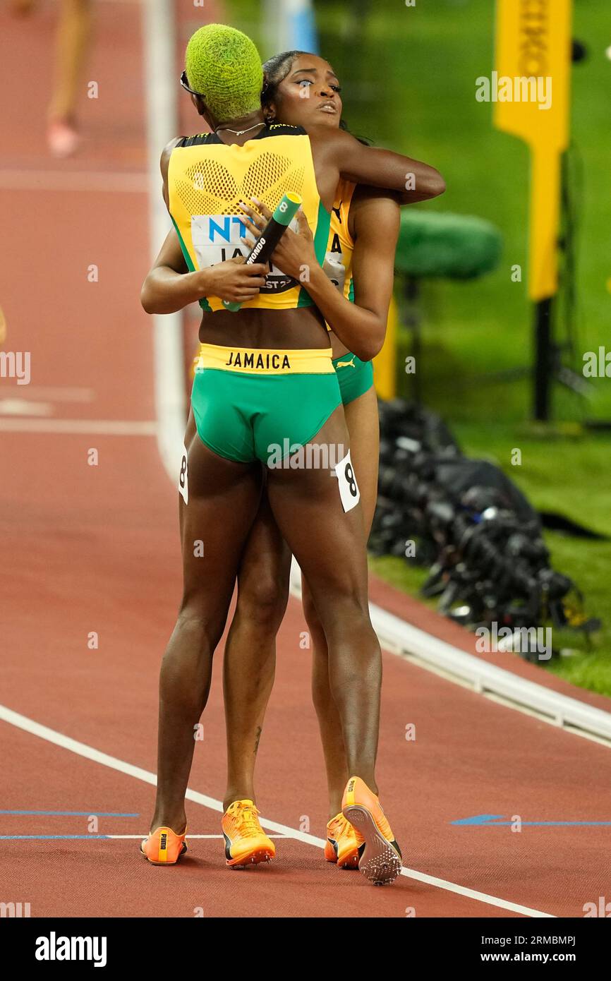 Silver medalists of Jamaica's team celebrate after the final of the Women's 4x400-meters relay ...
