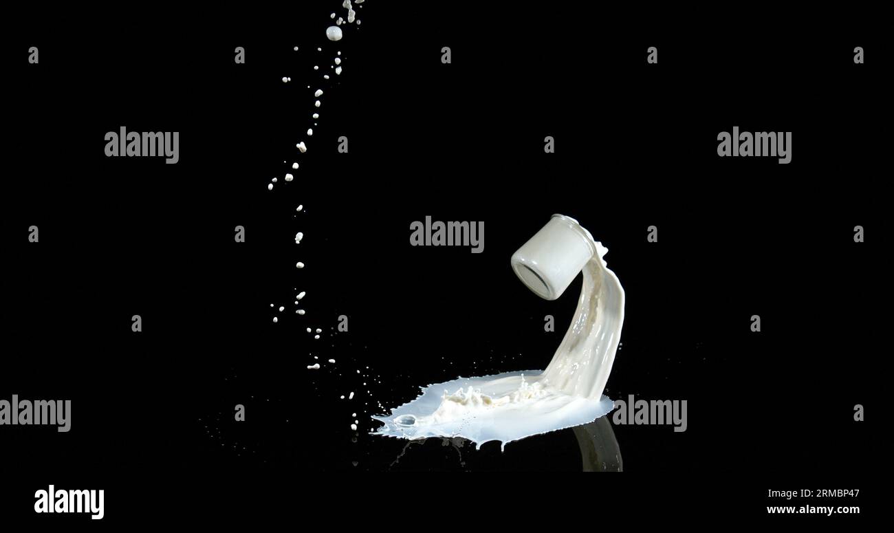 Glass of Milk Bouncing and Splashing on Black Background Stock Photo ...