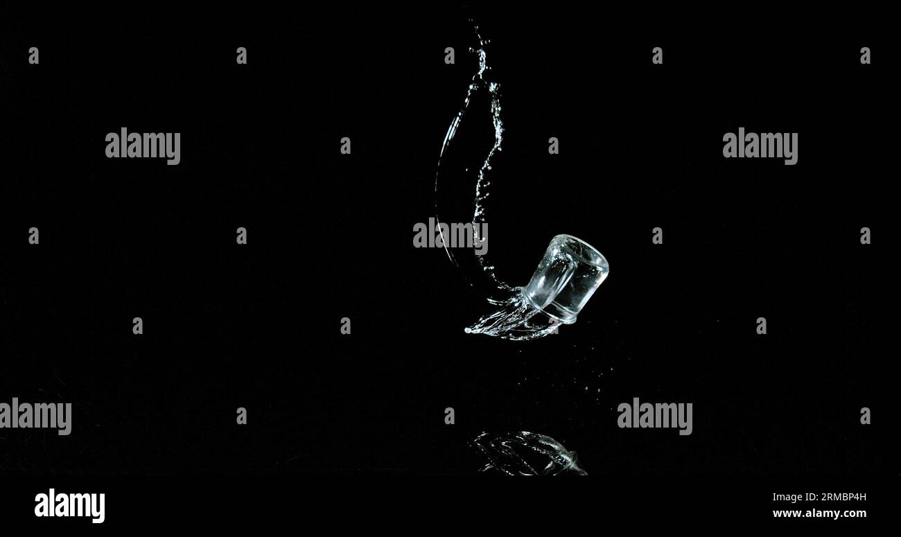 Glass of Water Bouncing and Splashing on Black Background Stock Photo ...