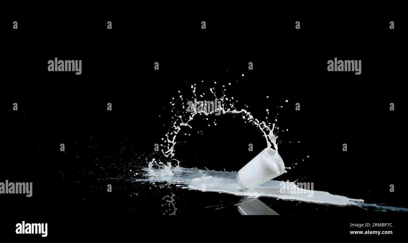 Glass of Milk Bouncing and Splashing on Black Background Stock Photo ...