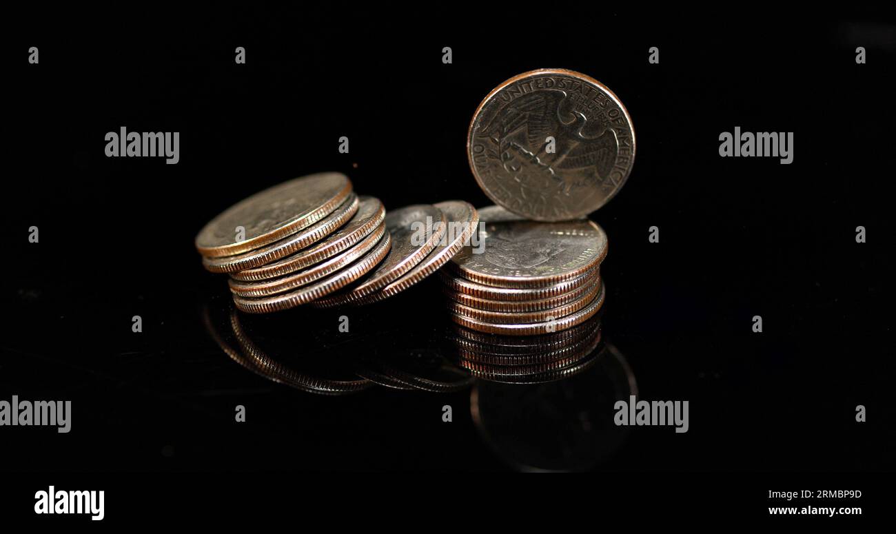 Quarter Dollar Coins Falling, Rolling and Sliding on Black Background ...
