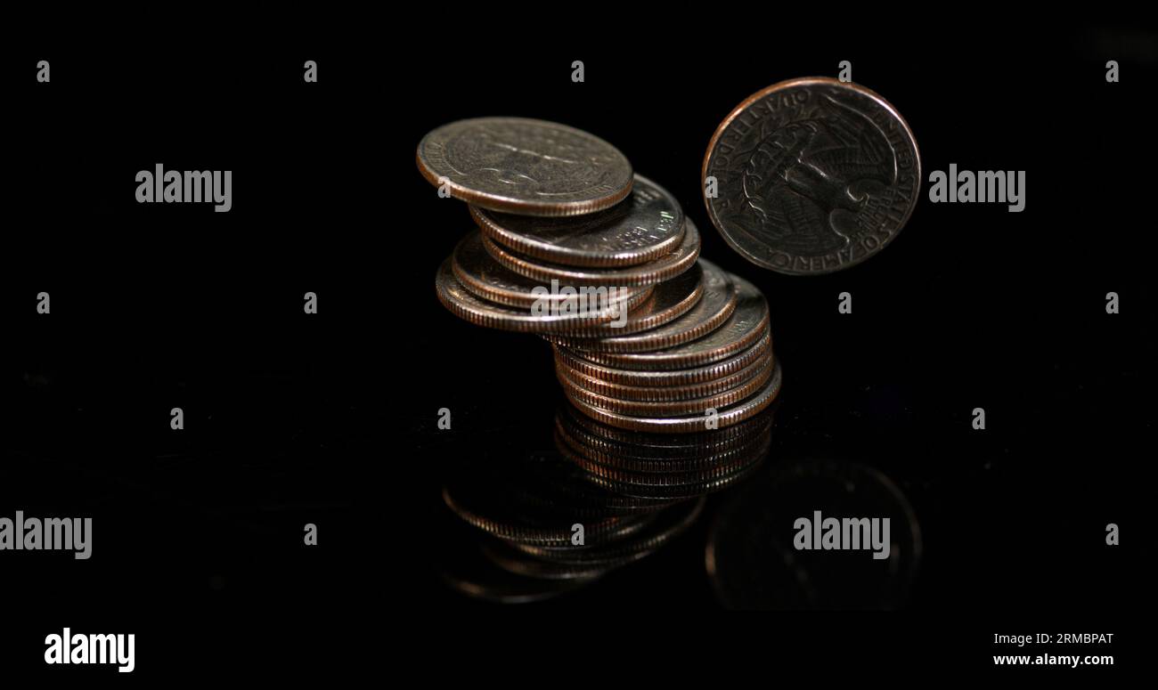 Quarter Dollar Coins Falling, Rolling and Sliding on Black Background ...