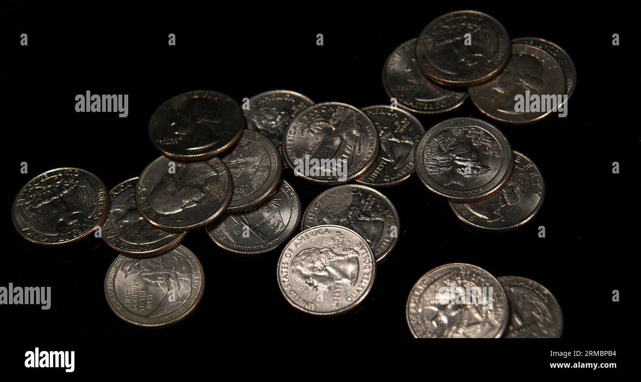 Quarter Dollar Coins Falling, Rolling and Sliding on Black Background ...