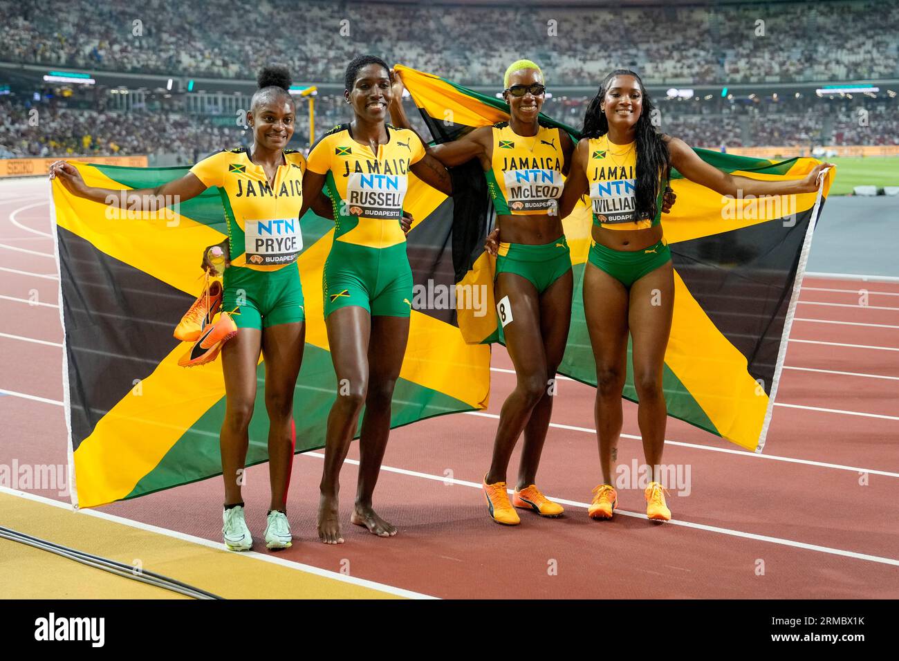 Silver medalists of Jamaica's team celebrate after the final of the Women's 4x400-meters relay ...