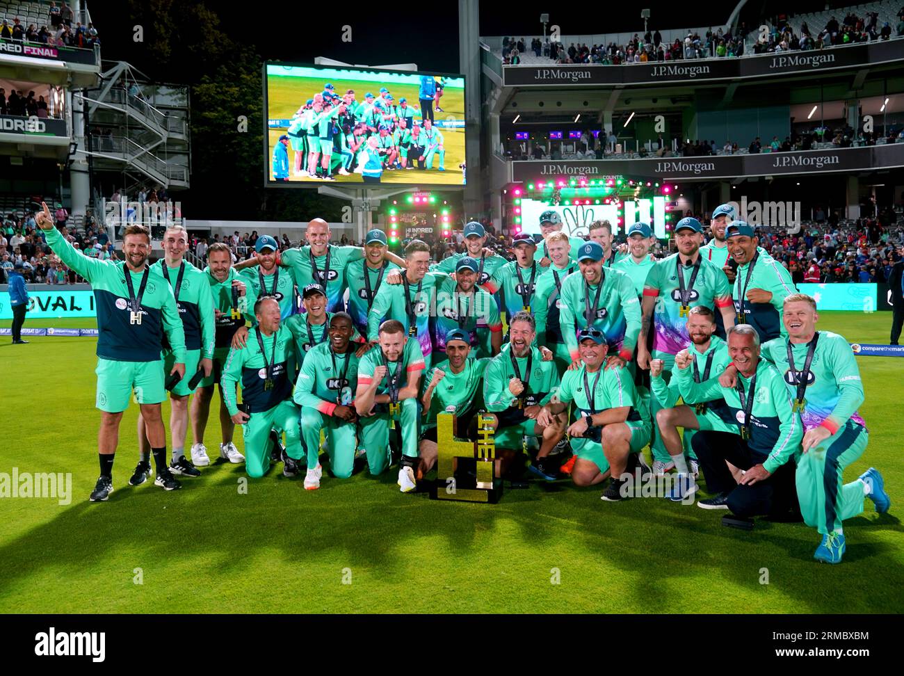 Oval Invincibles' players and staff celebrate with the trophy after ...