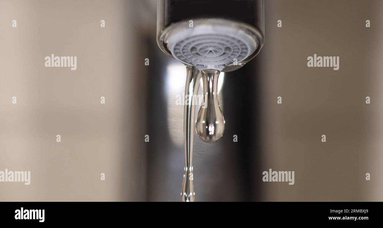 Water Flowing from the Tap, making a drop of water Stock Photo - Alamy