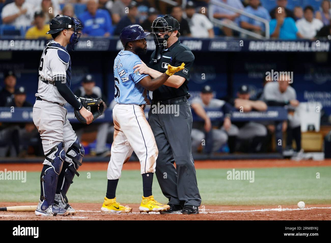 Home plate umpire Adam Beck restrains the Tampa Bay Rays' Randy ...