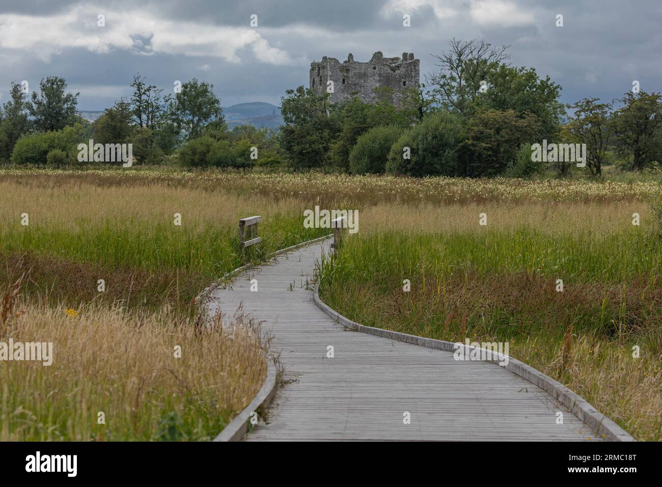 Looking down a pathway towards a derelict castle in scotland Stock ...