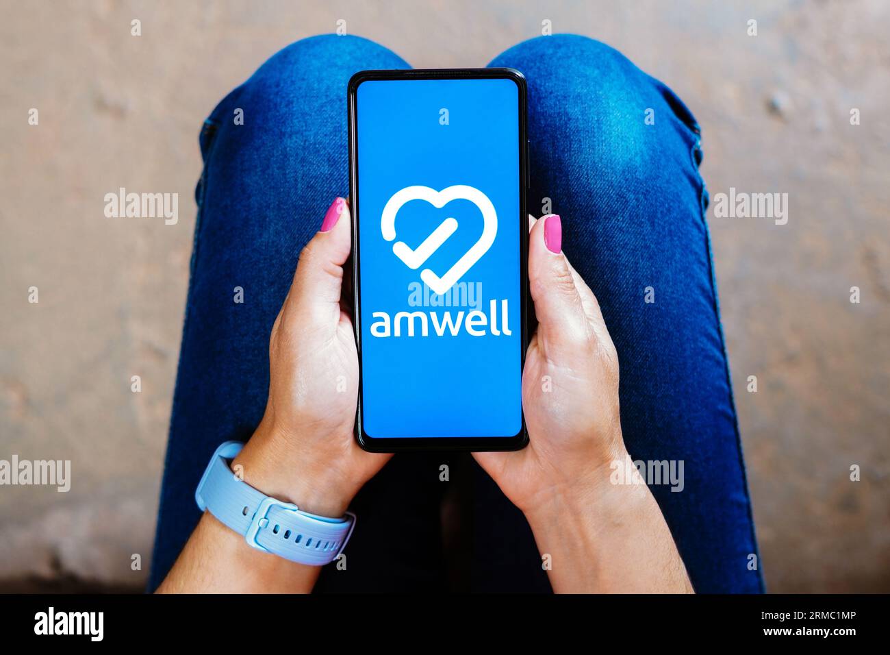 In this photo illustration, the Amwell logo seen displayed on a ...