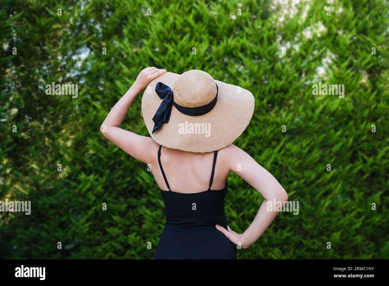 Overjoyed and excited young lady posing in front of a green background ...