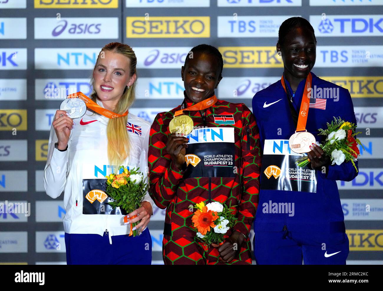 Kenya's Mary Moraa (centre) celebrates on the podium with her gold ...