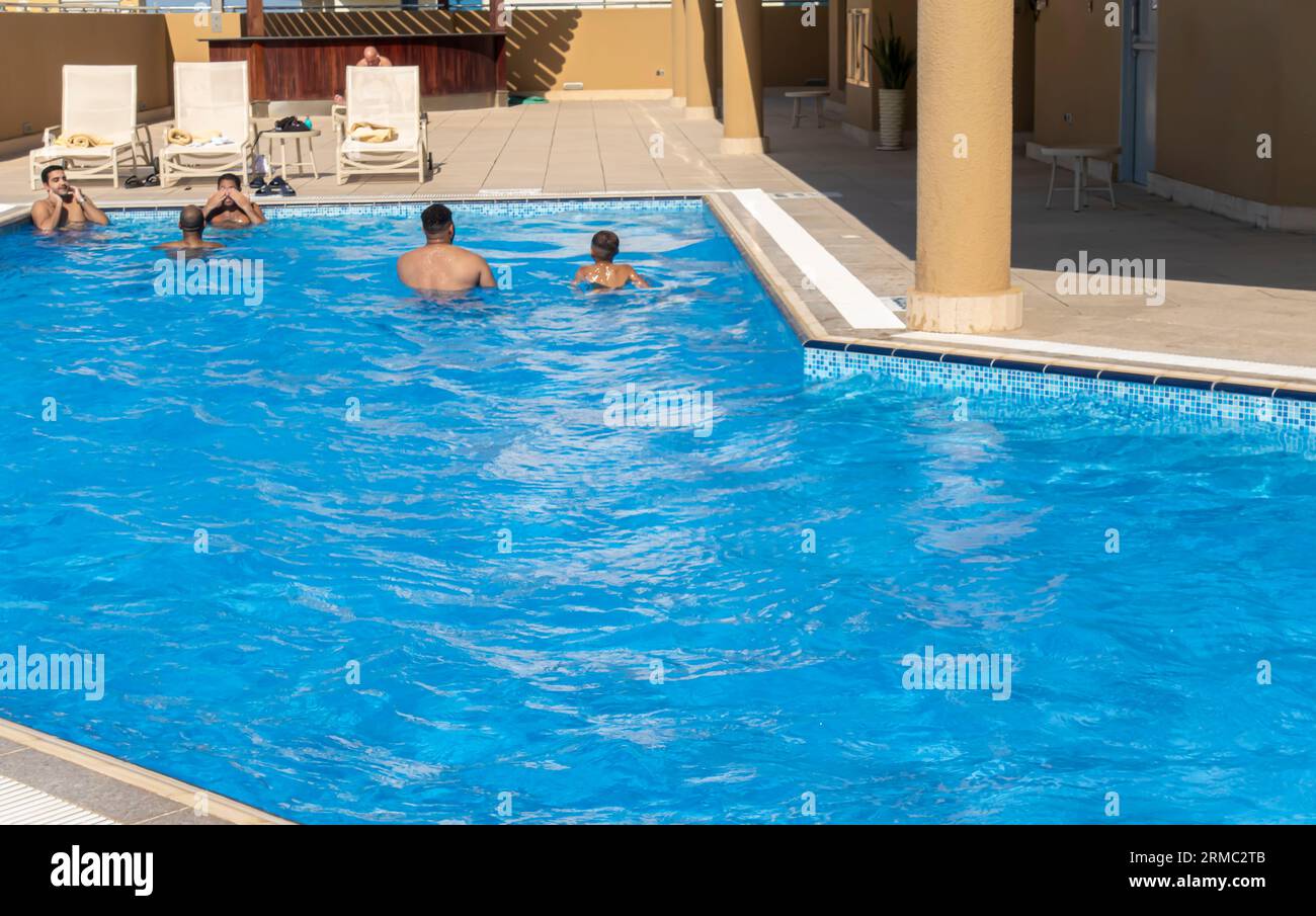 People swim in outdoor roof pool Stock Photo - Alamy