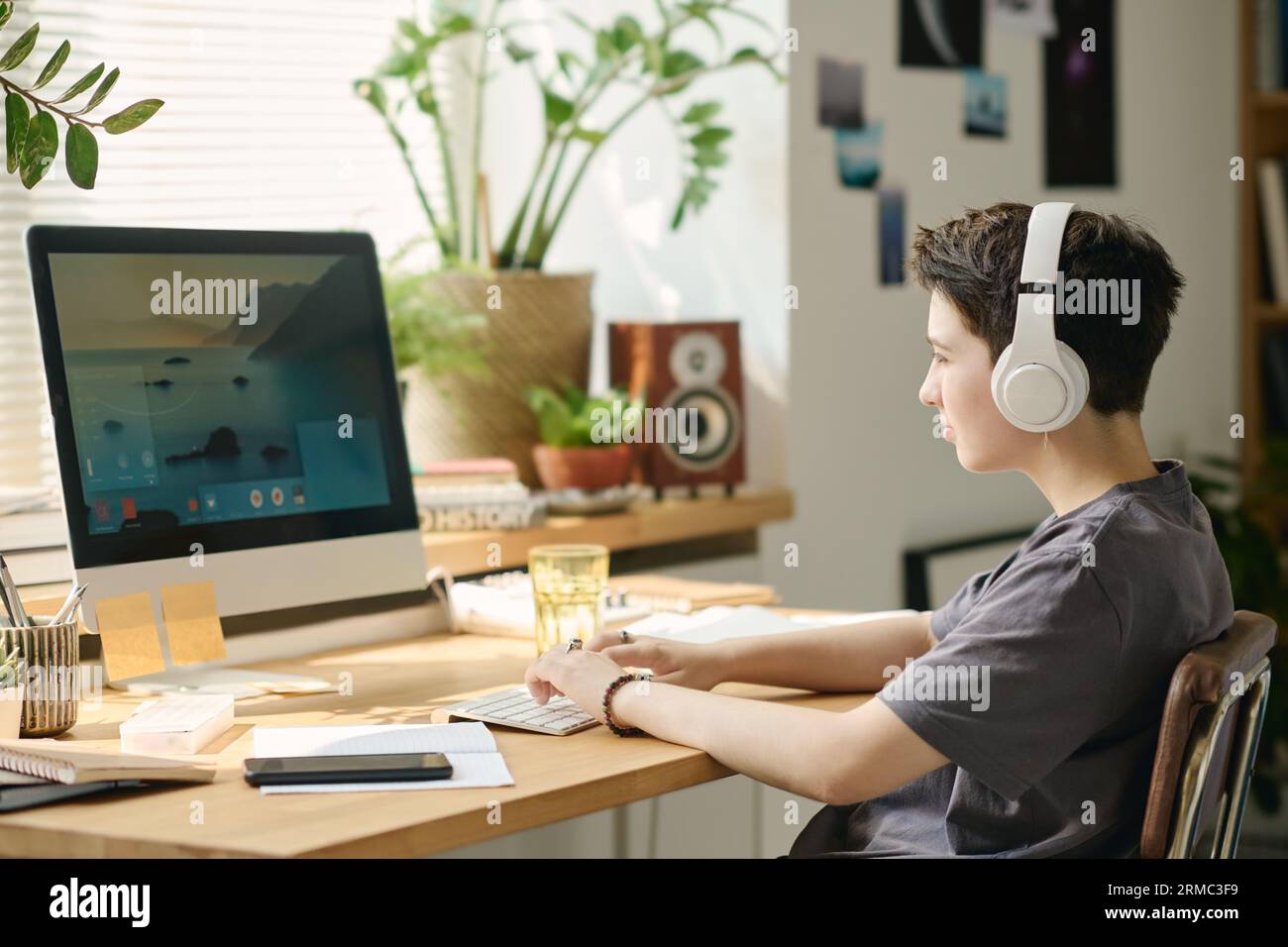 Side view of serious female teenager listening to ambience music in ...