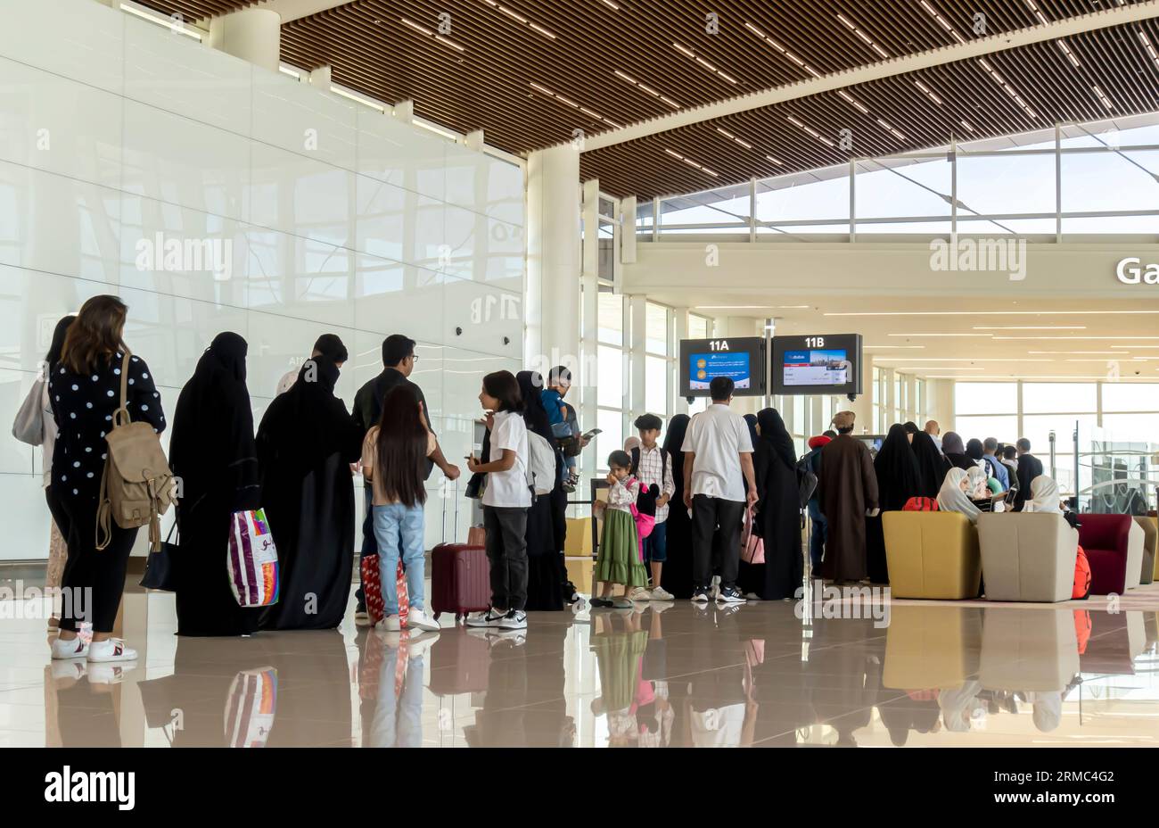 Passengers at the gates before departing in Bahrain airport terminal ...