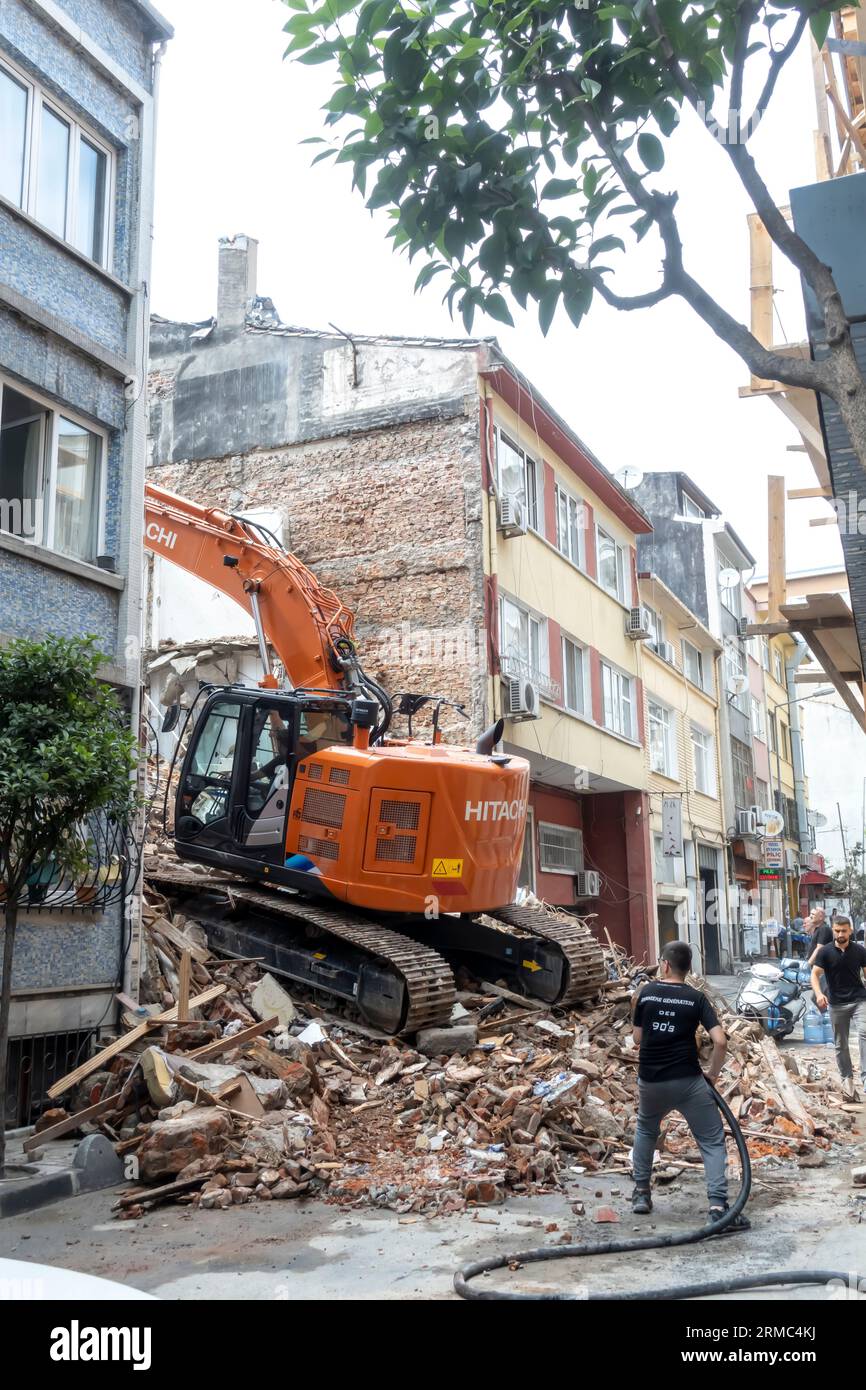 Hitachi Construction Excavator demolishing a building in a narrow ...